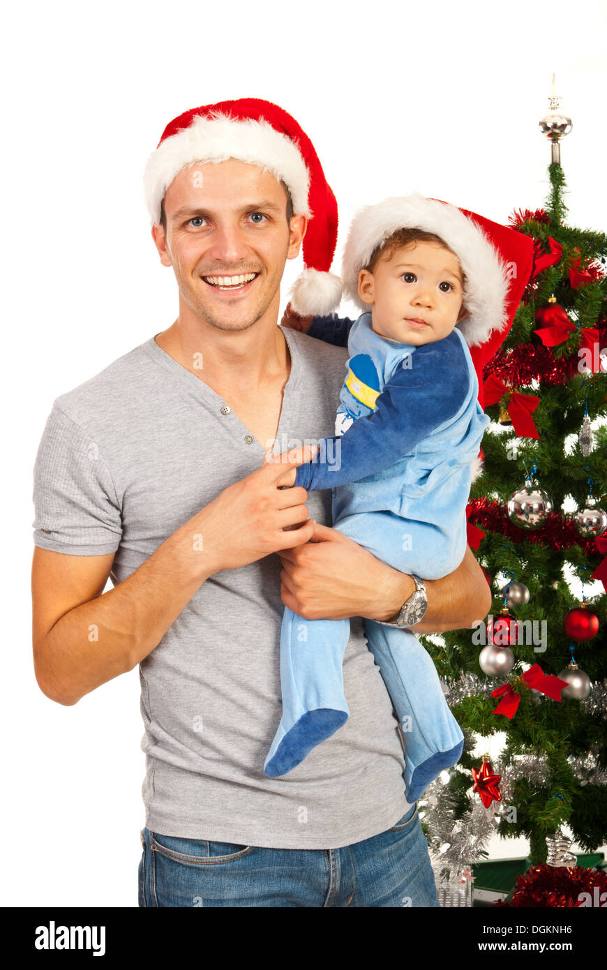 Happy father with baby boy in front of Christmas tree Stock Photo - Alamy