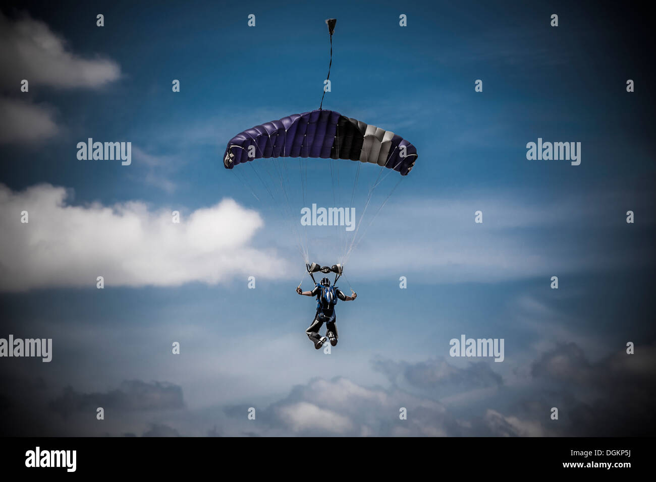 Skydiver landing with parachute open and making mid-air controls Stock ...