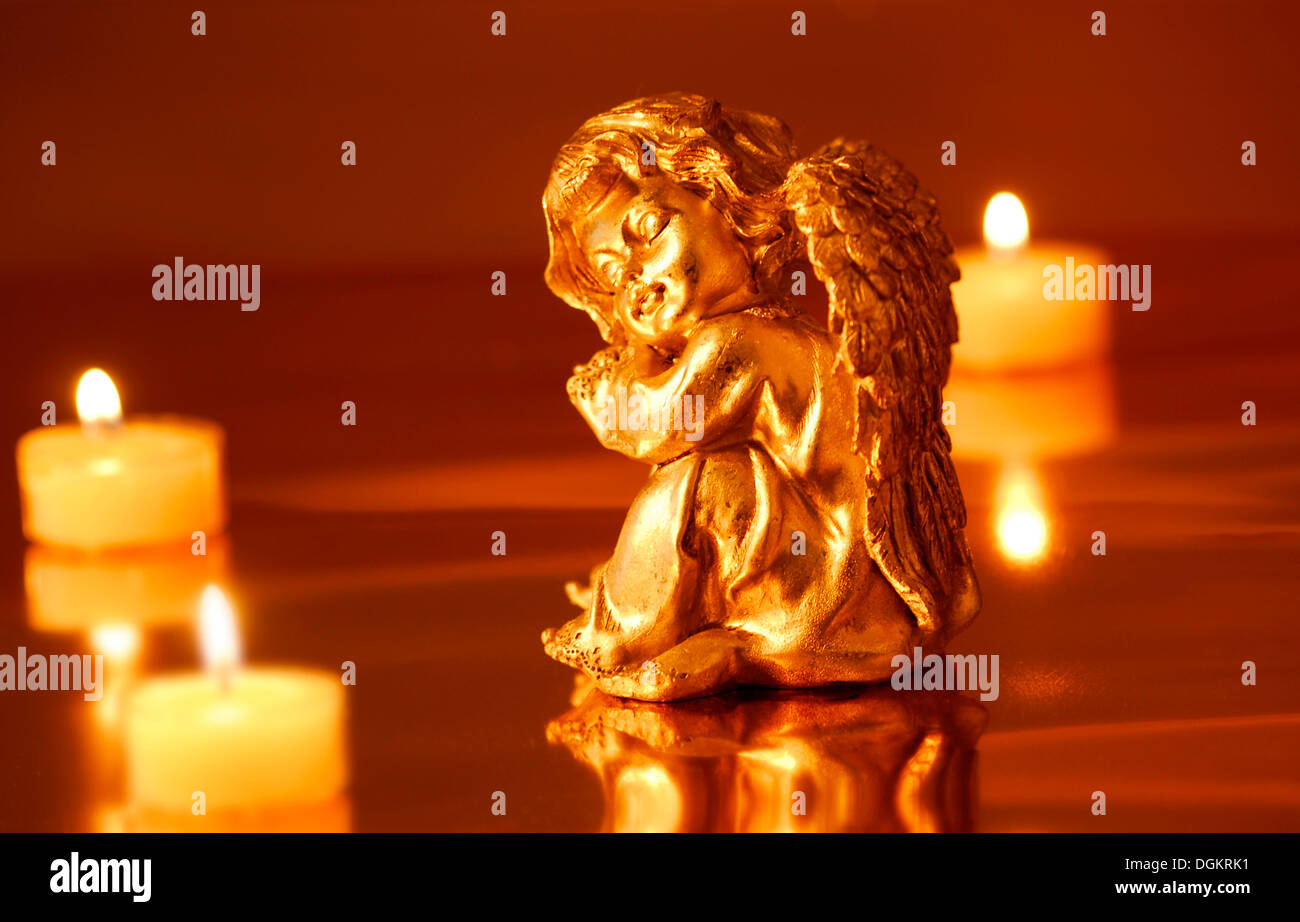 Candles angel sculpture golden hi-res stock photography and images - Alamy