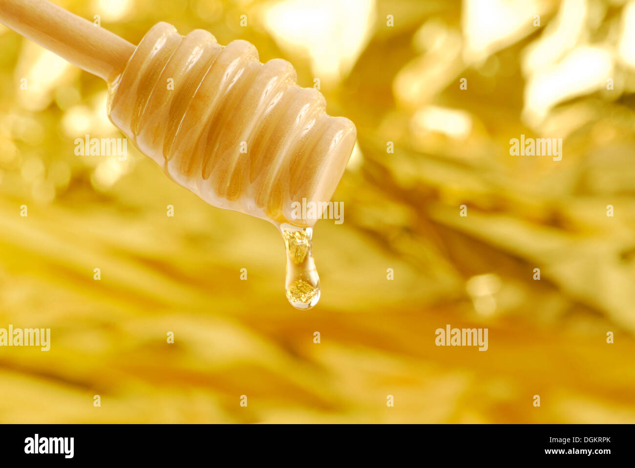 Drop of honey on a honey spoon Stock Photo - Alamy