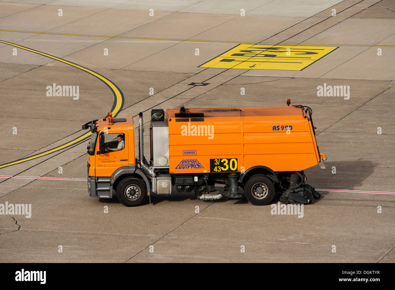 Sweeper in action on the runway, Duesseldorf International Airport ...