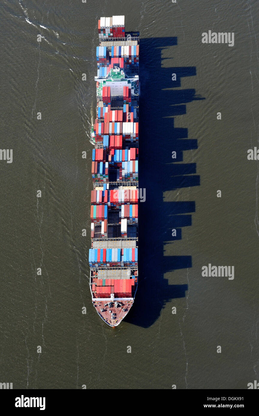 Aerial view, container ship on the Elbe River, with long shadows of the ...