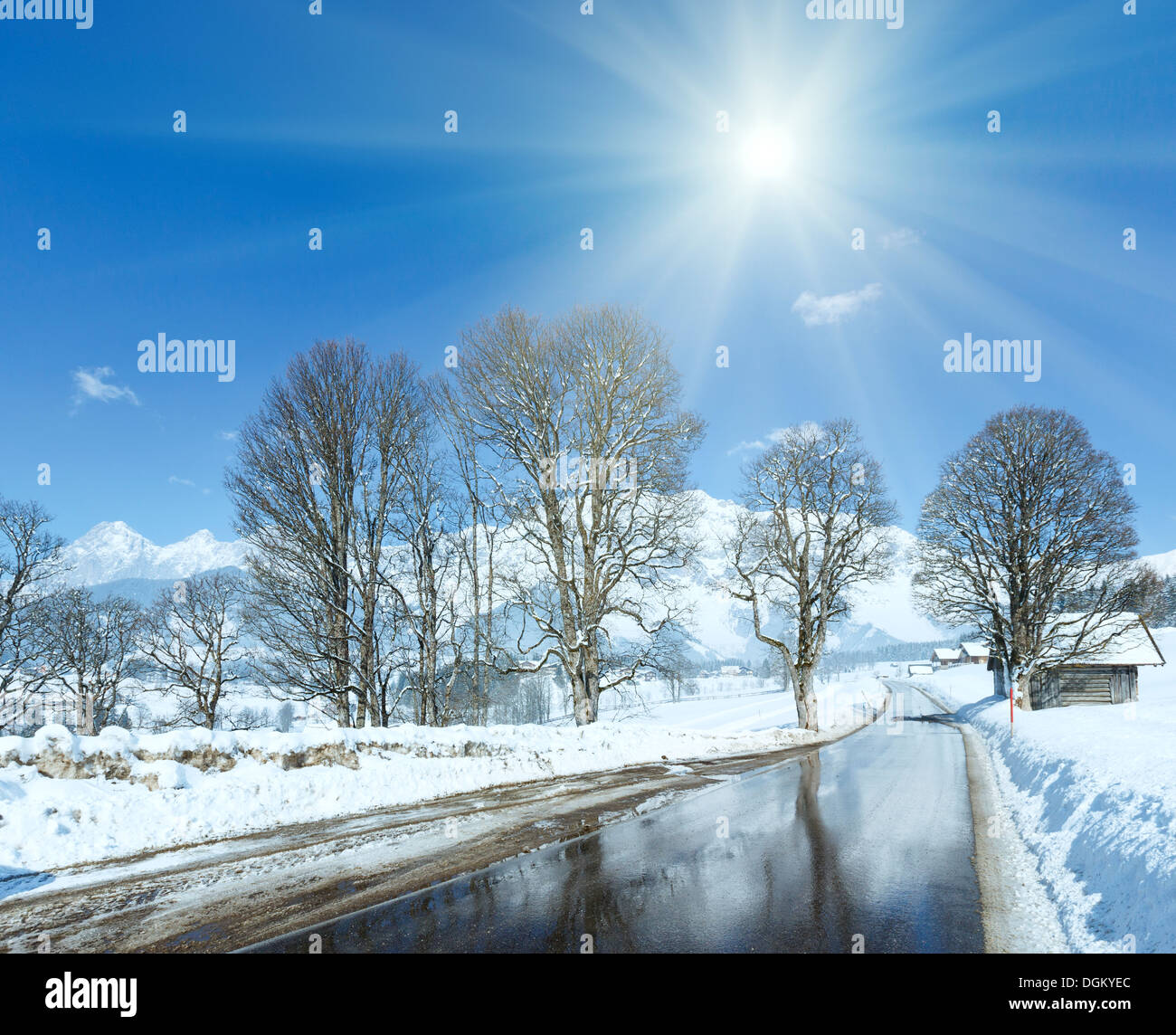 Spring sunshine and road through the alpine village in Austria with ...