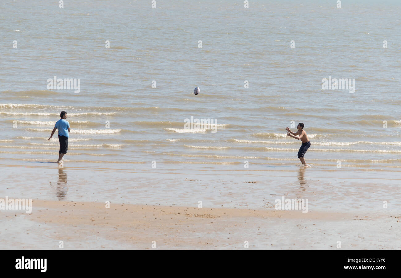 Playing rugby on the beach Stock Photo - Alamy