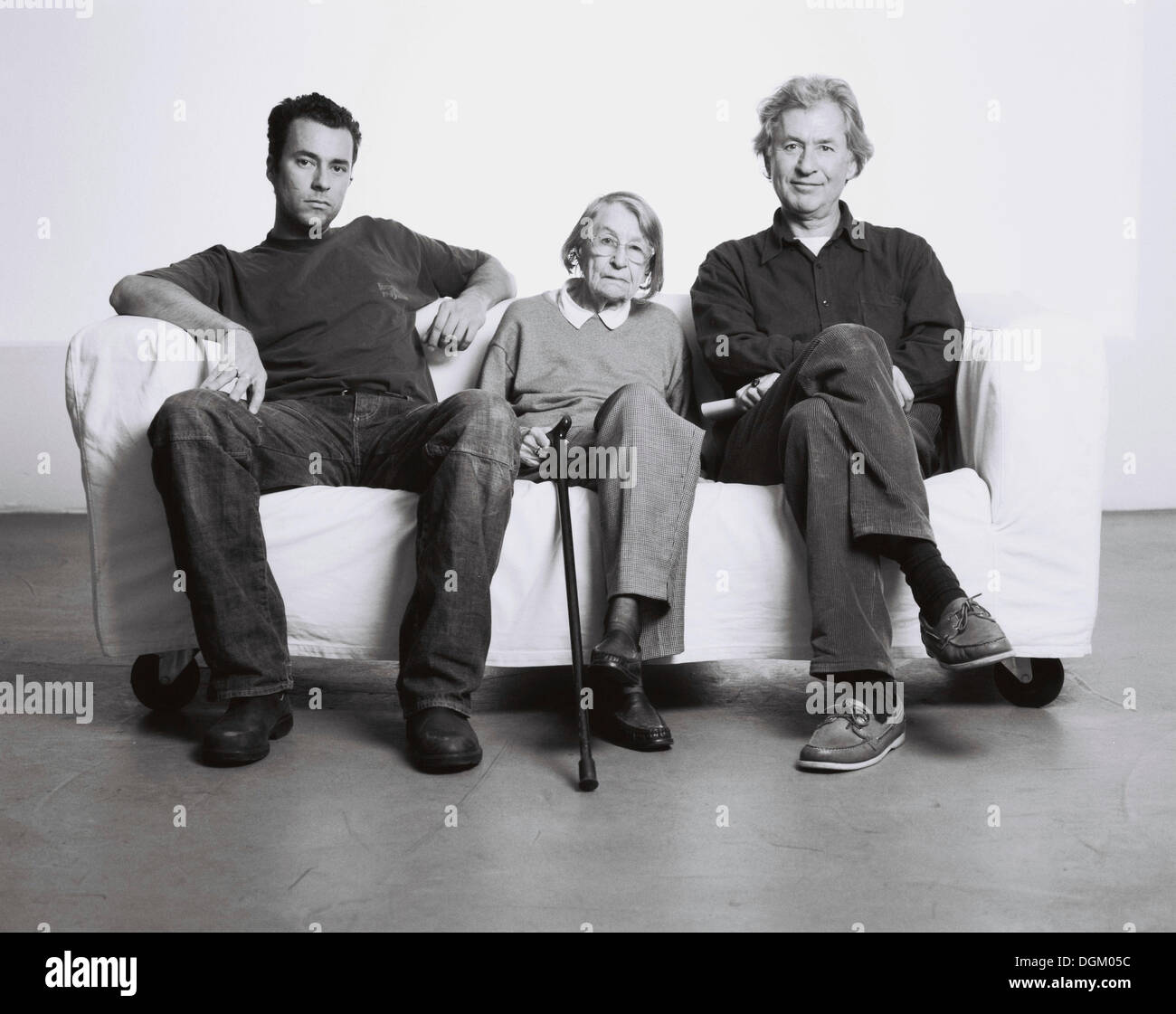 Three generations, a grandmother, her son and her grandson sitting on a ...