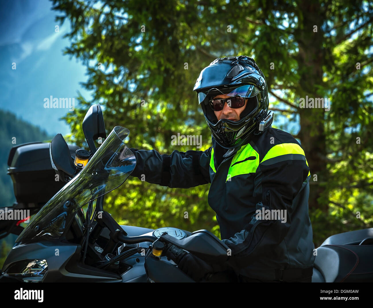 Portrait of cool biker on beautiful nature background, handsome man ...