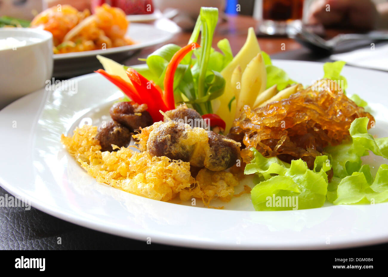 Thai food, rice in cold water served with fried sweet pork,fried egg ...