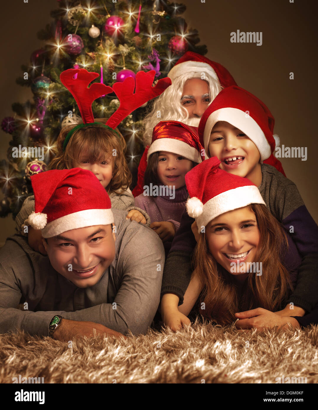Closeup portrait of big happy family with Santa Claus lying down near ...