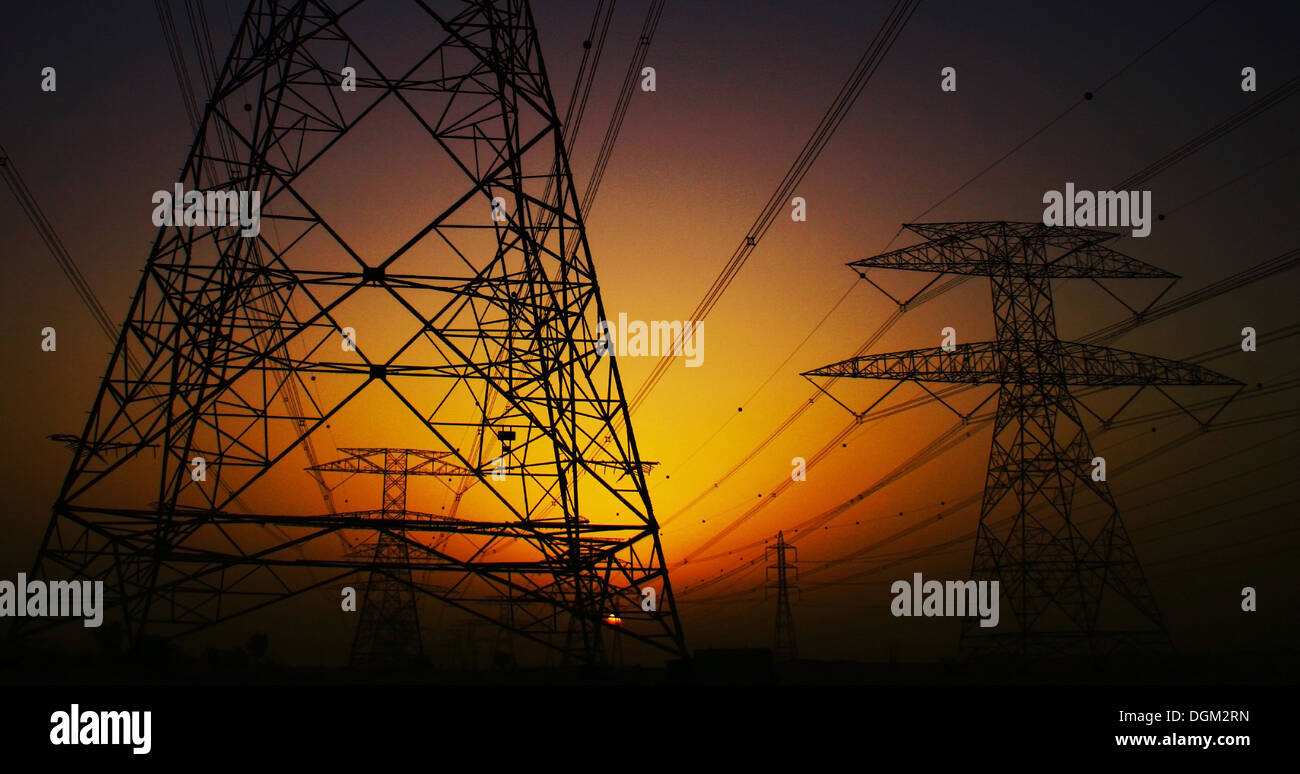 Electricity Pylon over dark sunset sky, environmental damage concept ...