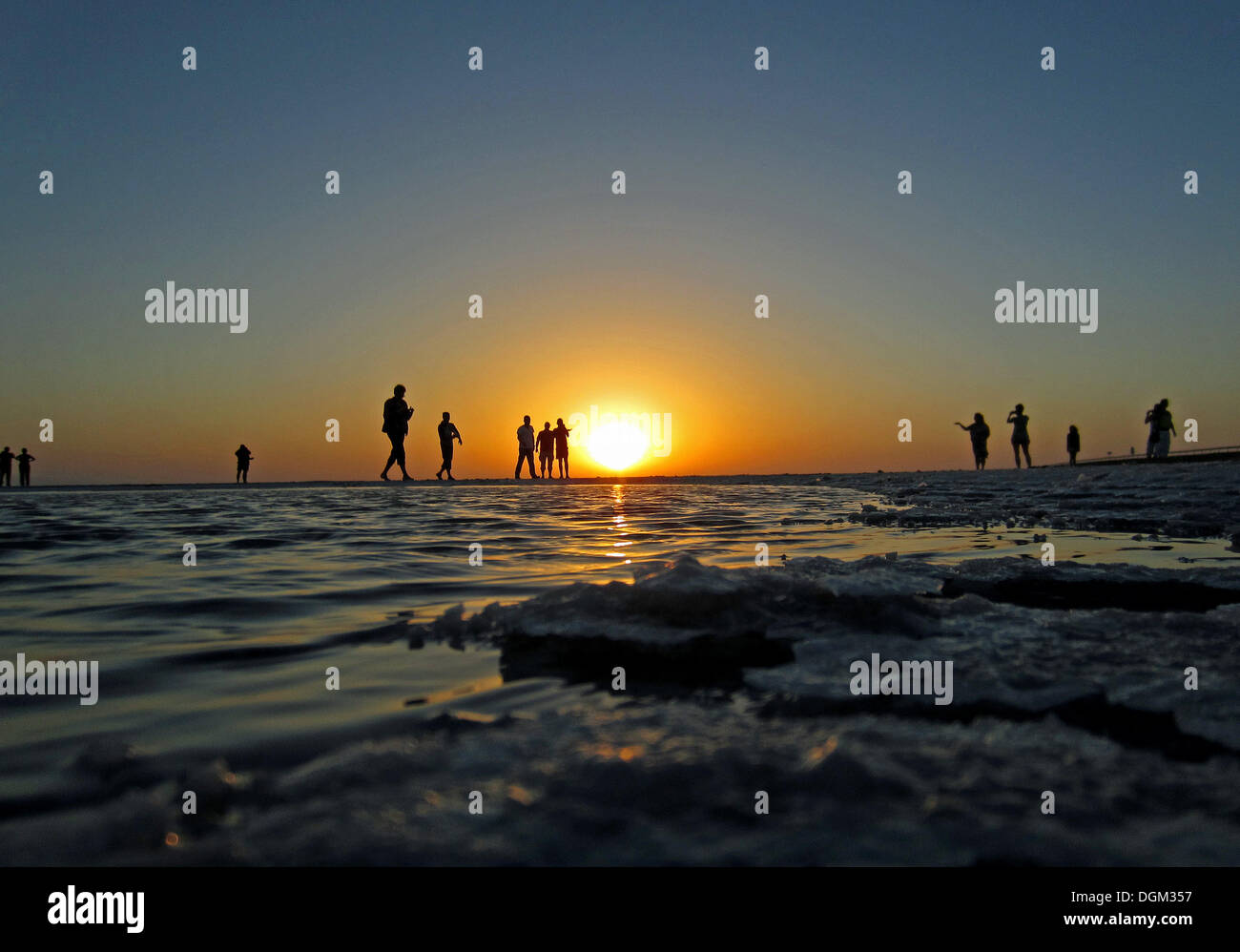 Tourists walk through Chott el Djerid lake near Tozeur, Tunisia, at ...