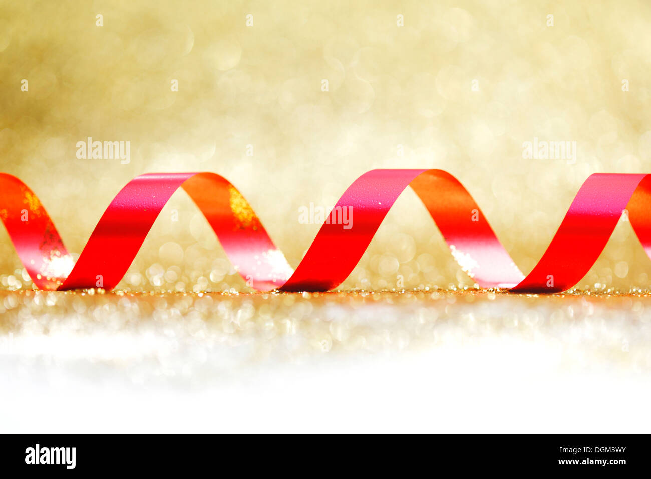 Red curly ribbon decoration on shiny background Stock Photo - Alamy