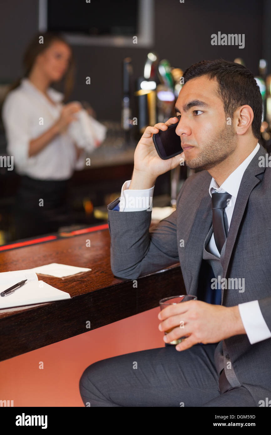 Serious businessman having a phone call Stock Photo - Alamy