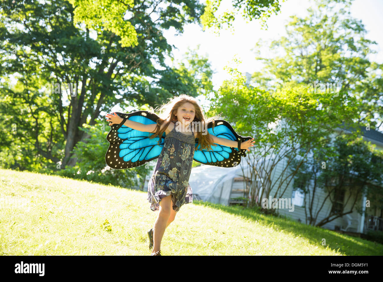 child running across lawn in front of farmhouse wearing large ...