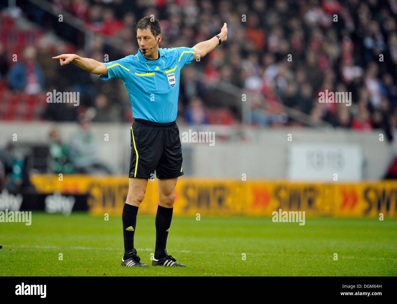 Referee Wolfgang Stark showing foul play, awarding a free kick ...