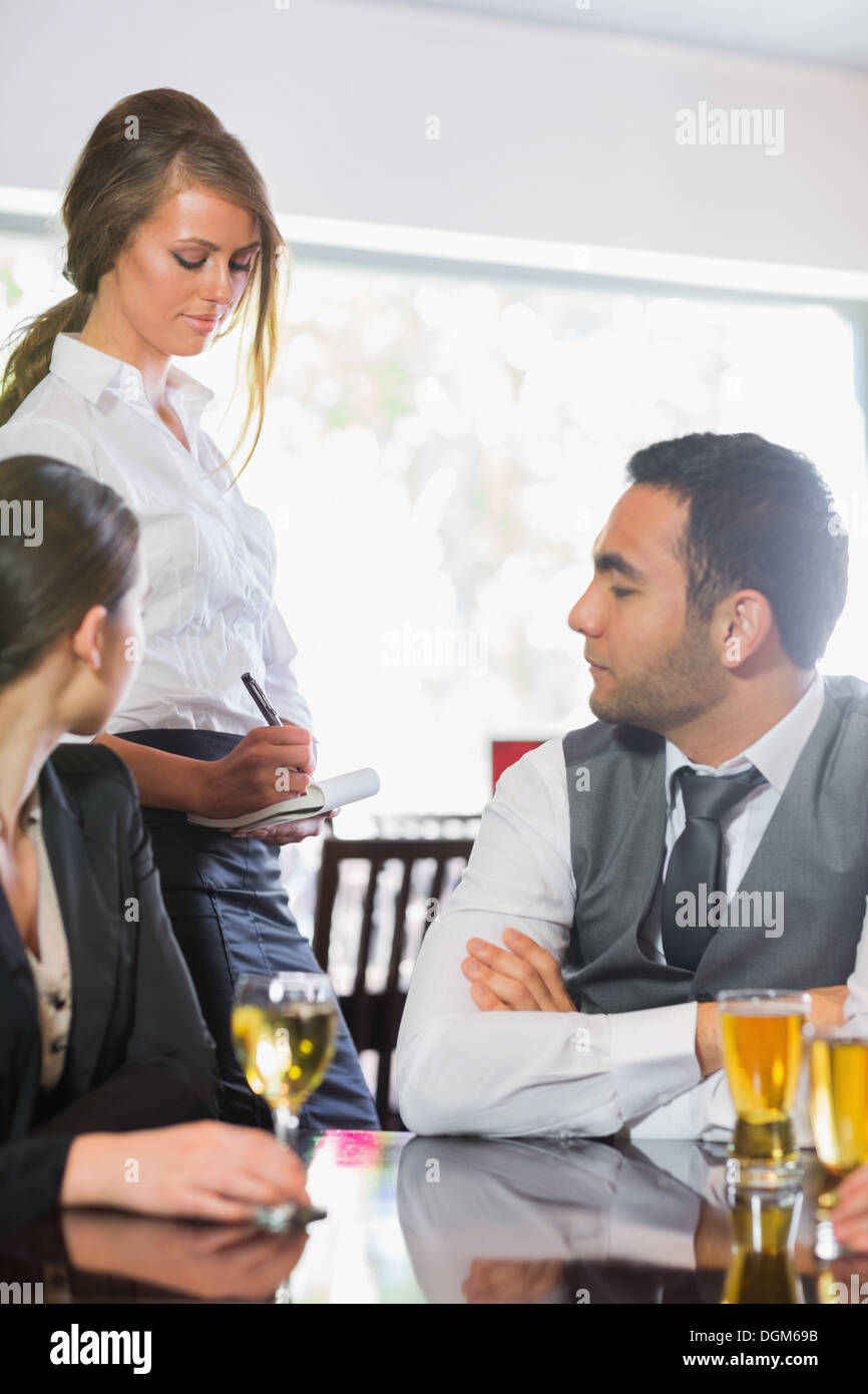 Business people ordering a dinner from waitress Stock Photo - Alamy