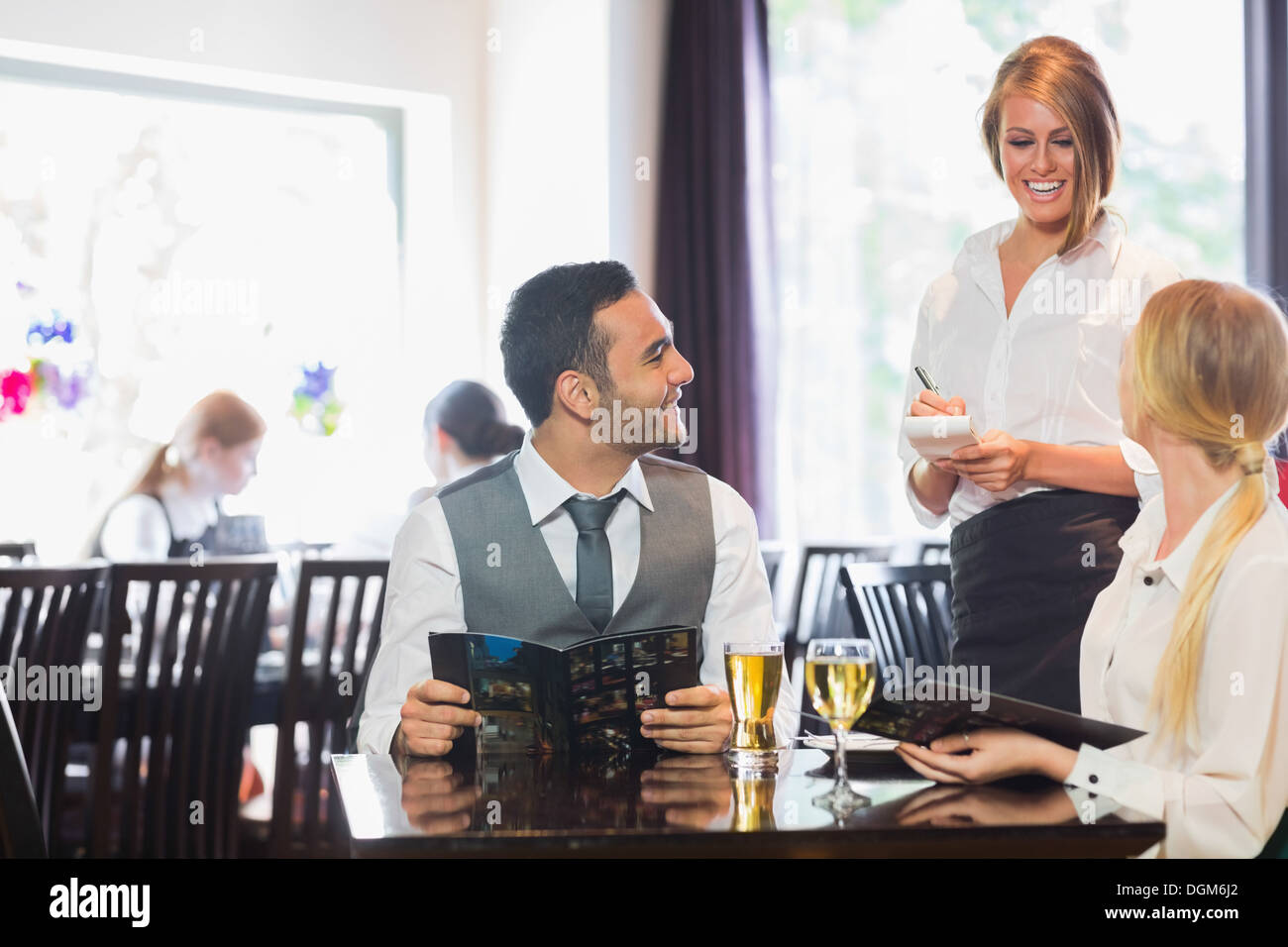 Woman holding menu ordering hi-res stock photography and images - Alamy