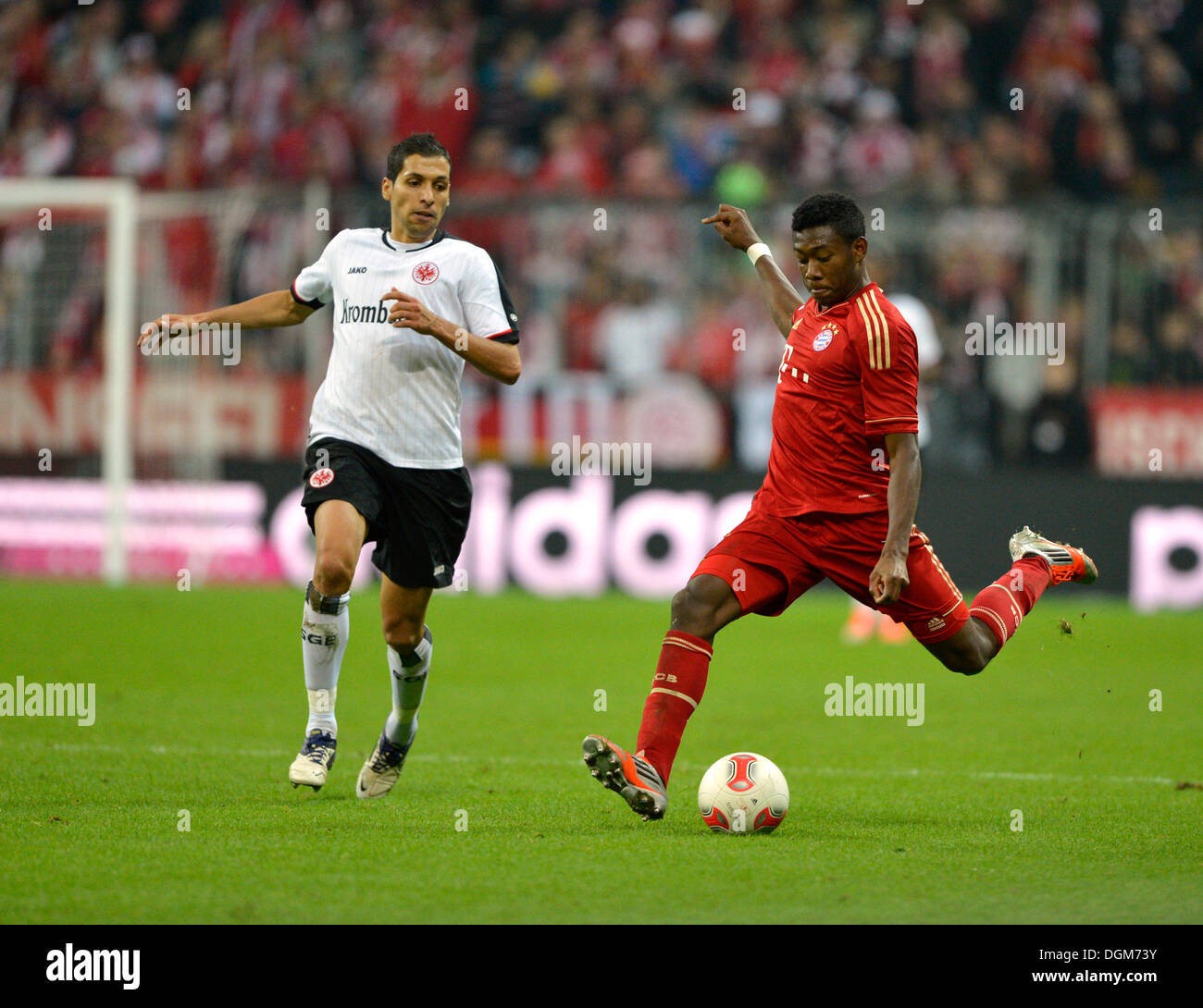 David Alaba, FC Bayern Munich, right, kicking the ball a, and Karim ...