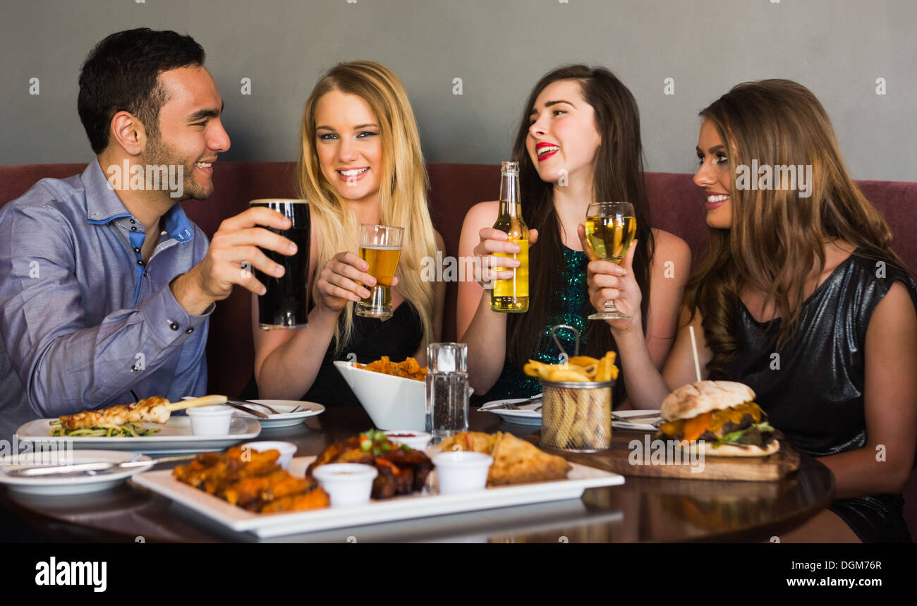 Friends having dinner together and toasting Stock Photo - Alamy