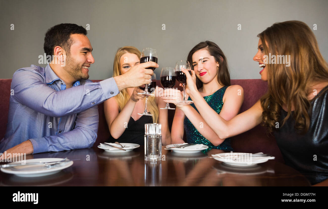 Happy friends drinking red wine in a bar Stock Photo - Alamy