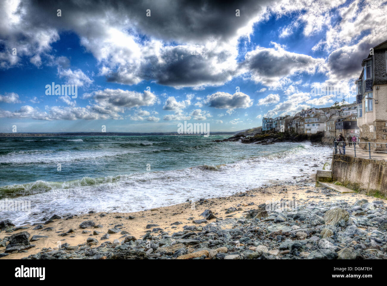 Blue sky dark clouds and rocky beach St Ives Cornwall England in HDR ...