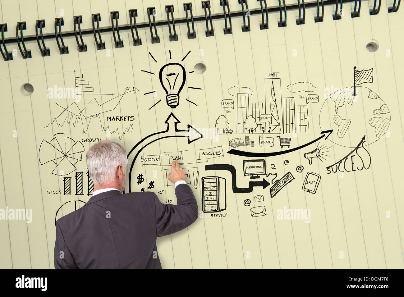 Rear view of businessman touching illustrations on huge notepad Stock ... Rear view of businessman touching illustrations on huge notepad Stock ...
