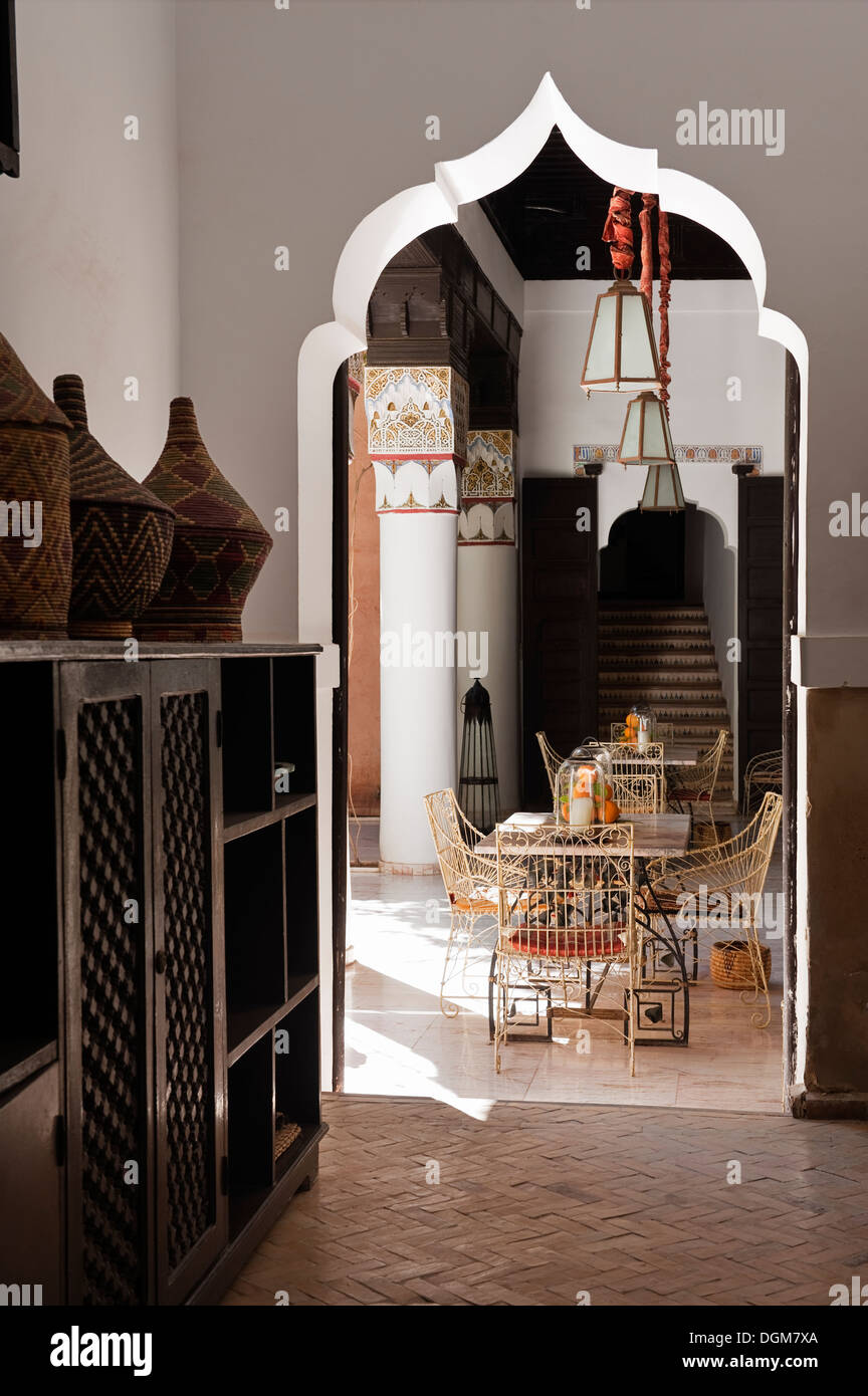 Ornate Moroccan archway onto outdoor riad dining area and garden Stock ...