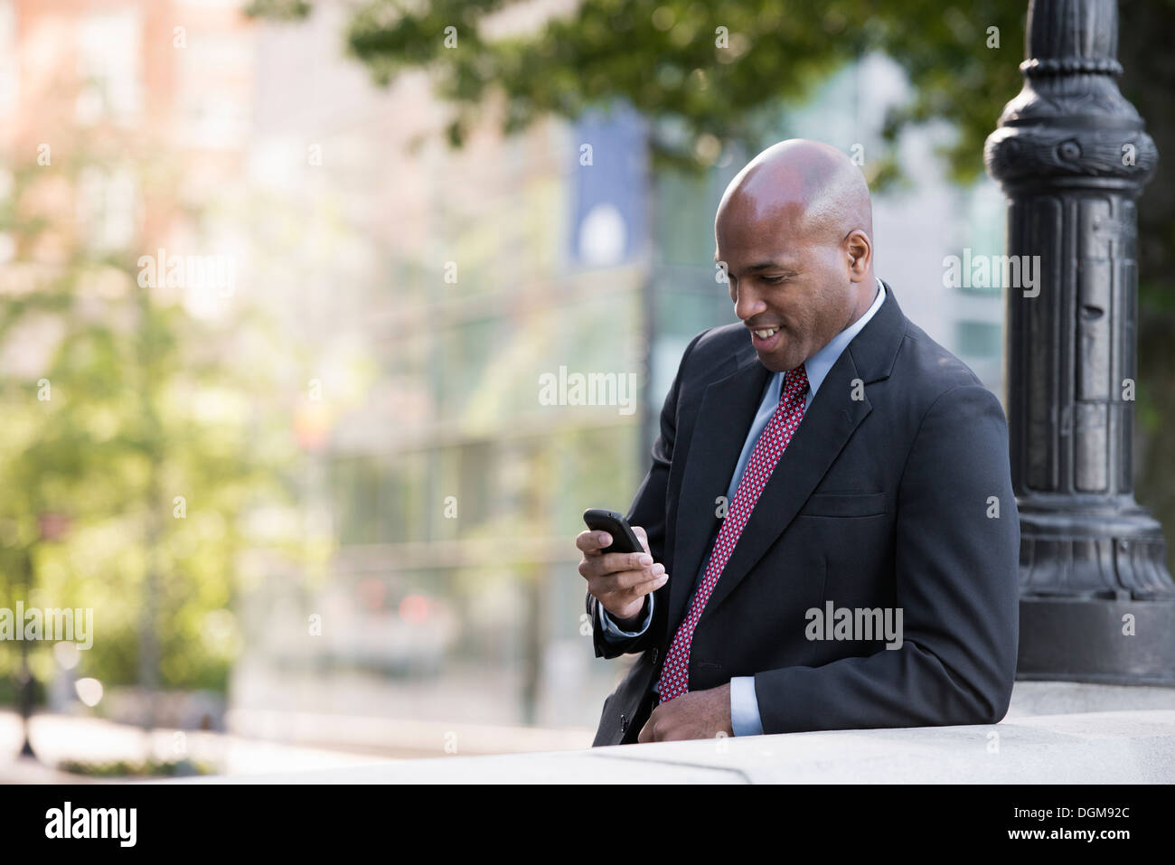 Business people. A man in a suit checking his phone Stock Photo - Alamy