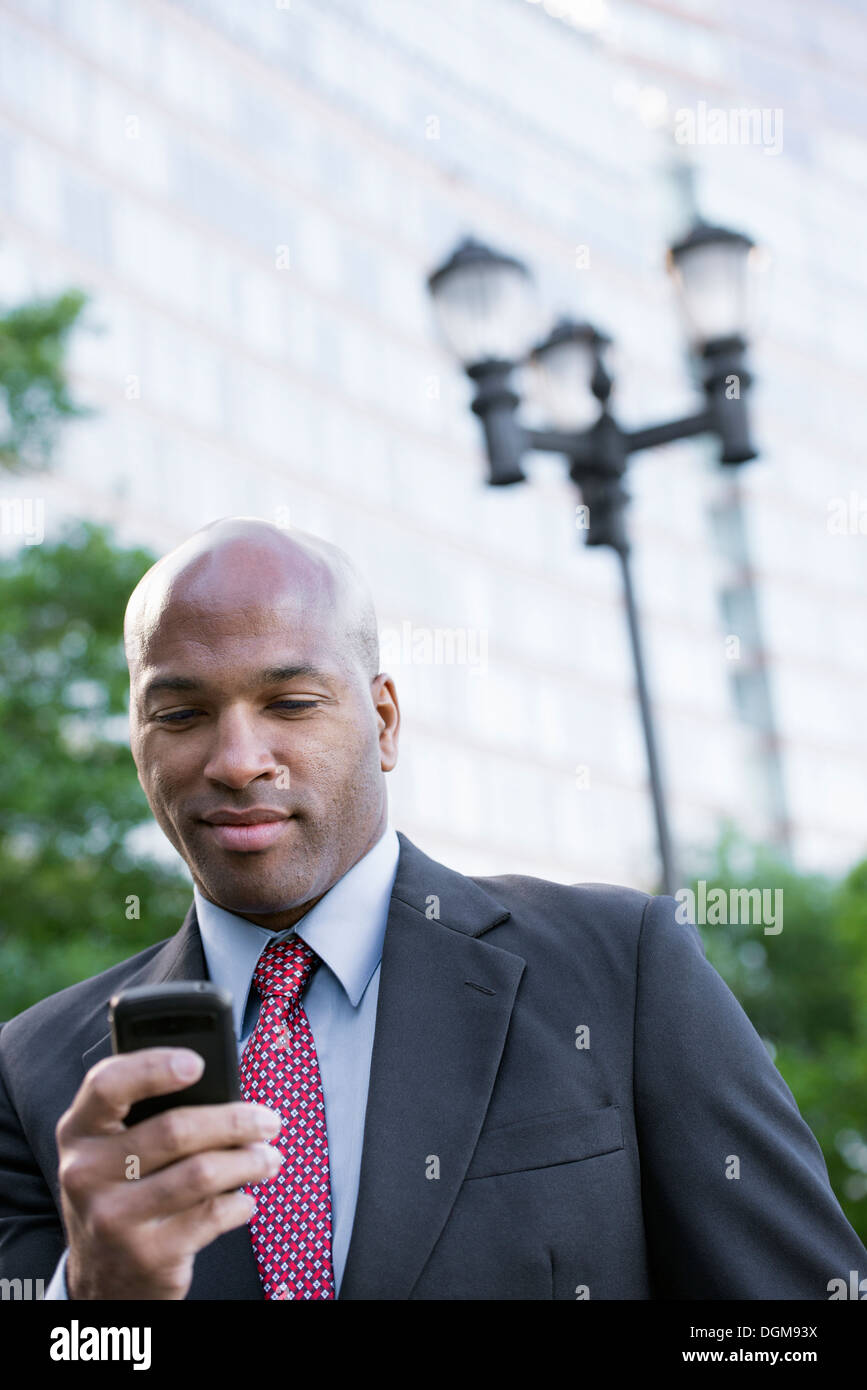 Business people. A man in a suit checking his phone Stock Photo - Alamy