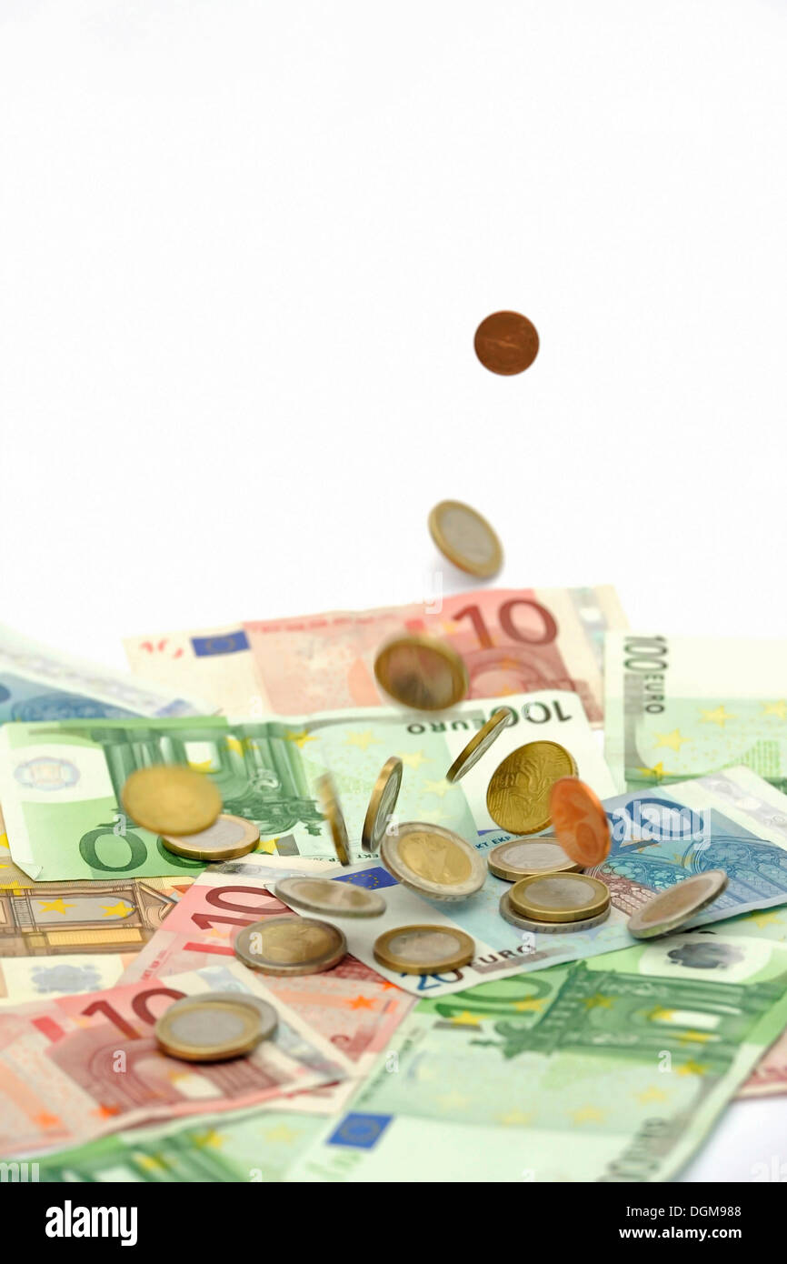 Euro coins falling on euro banknotes, raining money Stock Photo - Alamy