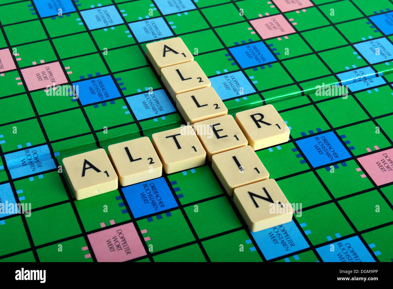 Scrabble letters forming the words Allein and Alter, German for being ...