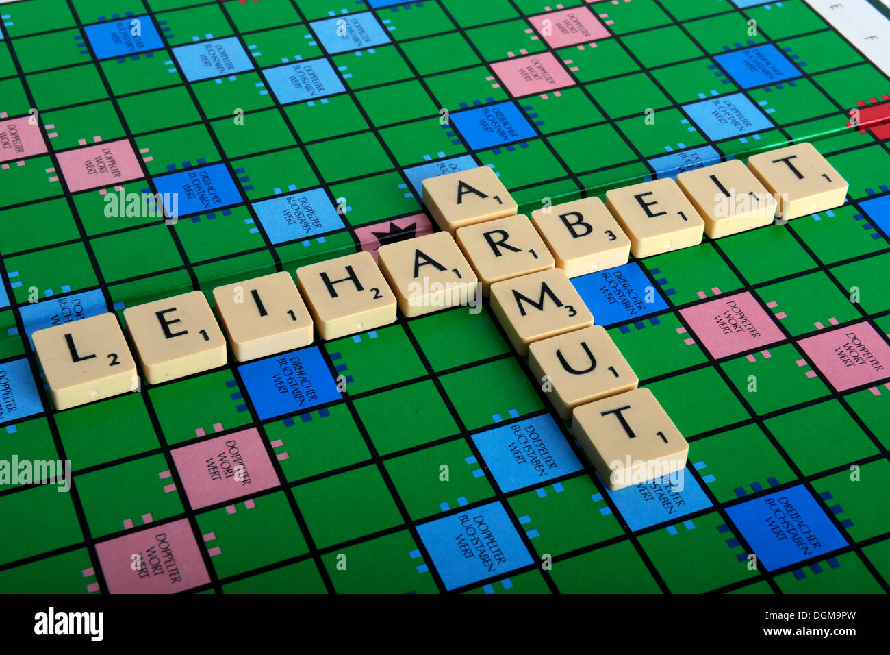 Scrabble letters forming the words Armut and Leiharbeit, German for ...