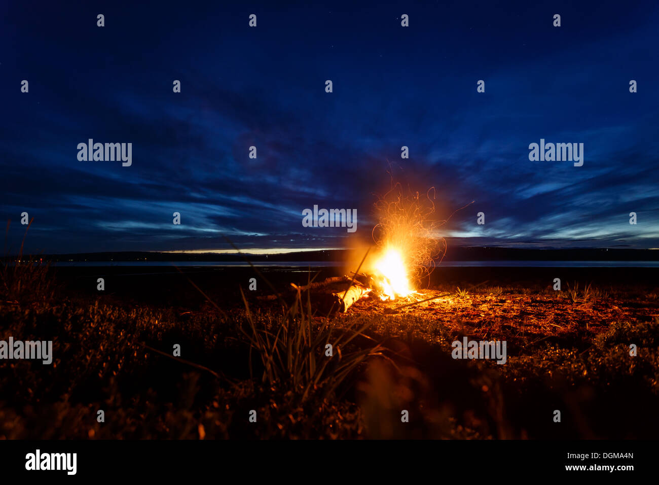 Campfire at twilight on beach in Alaska at sunset Stock Photo - Alamy