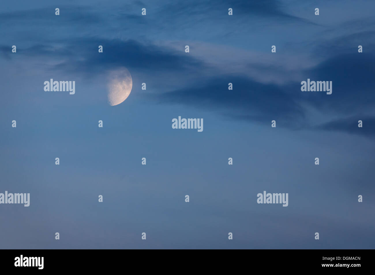Half Moon in blue sky at twilight Stock Photo - Alamy