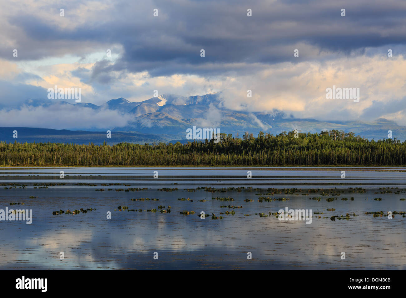 Alaskan lake reflecting mountains and clouds from surrounding ...