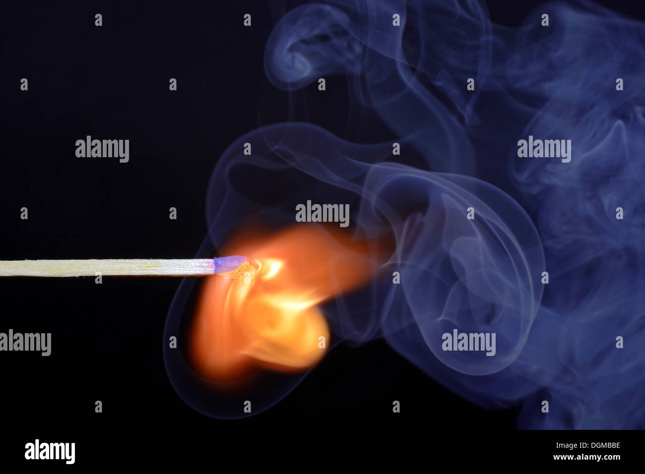 Matchstick being ignited, with blue smoke Stock Photo - Alamy