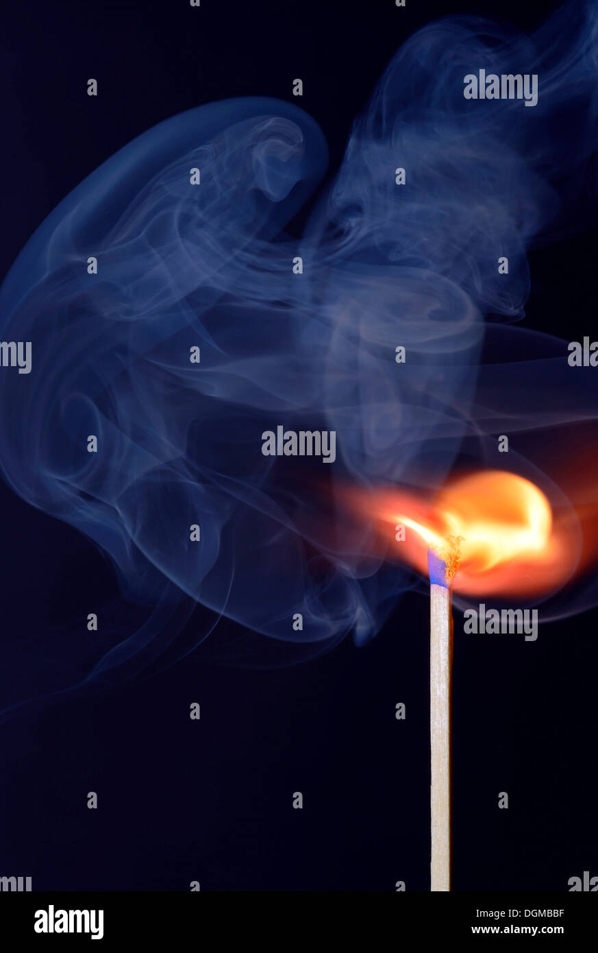 Matchstick being ignited, with blue smoke Stock Photo - Alamy