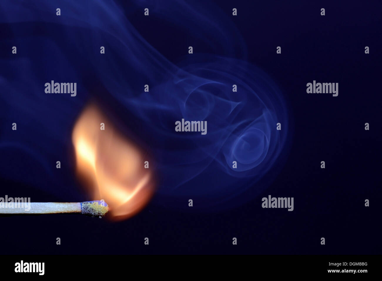Matchstick being ignited, with blue smoke Stock Photo - Alamy