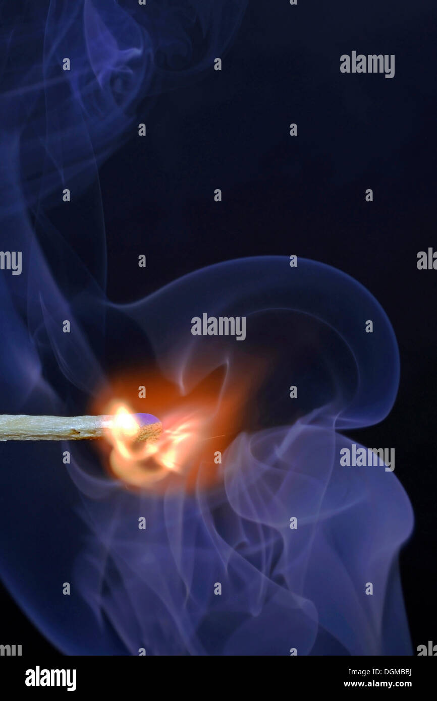 Matchstick being ignited, with blue smoke Stock Photo - Alamy