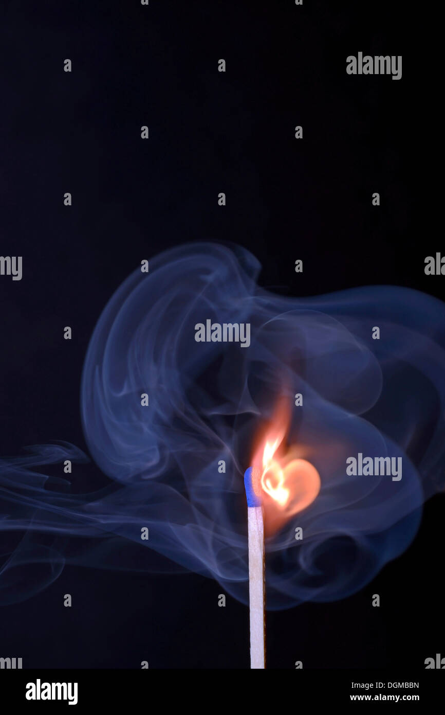 Matchstick being ignited, with blue smoke Stock Photo - Alamy