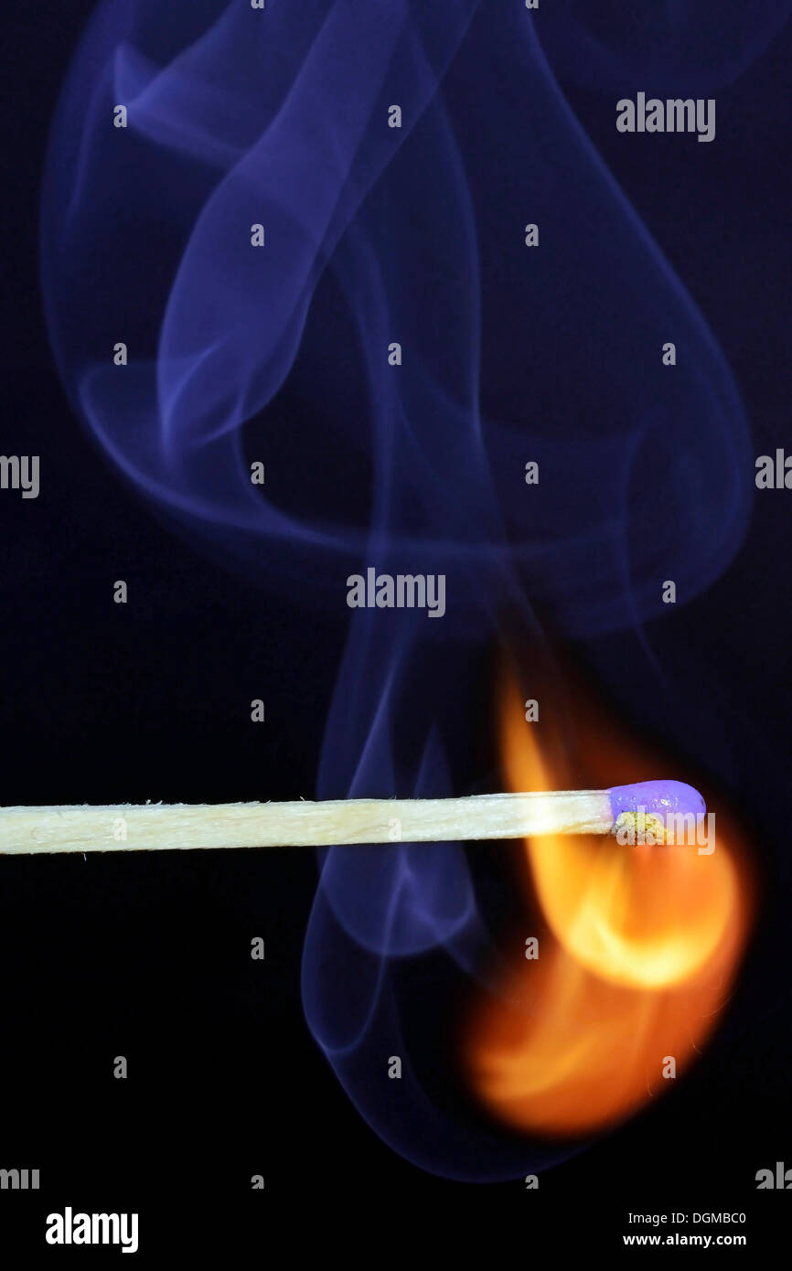 Matchstick being ignited, with blue smoke Stock Photo - Alamy