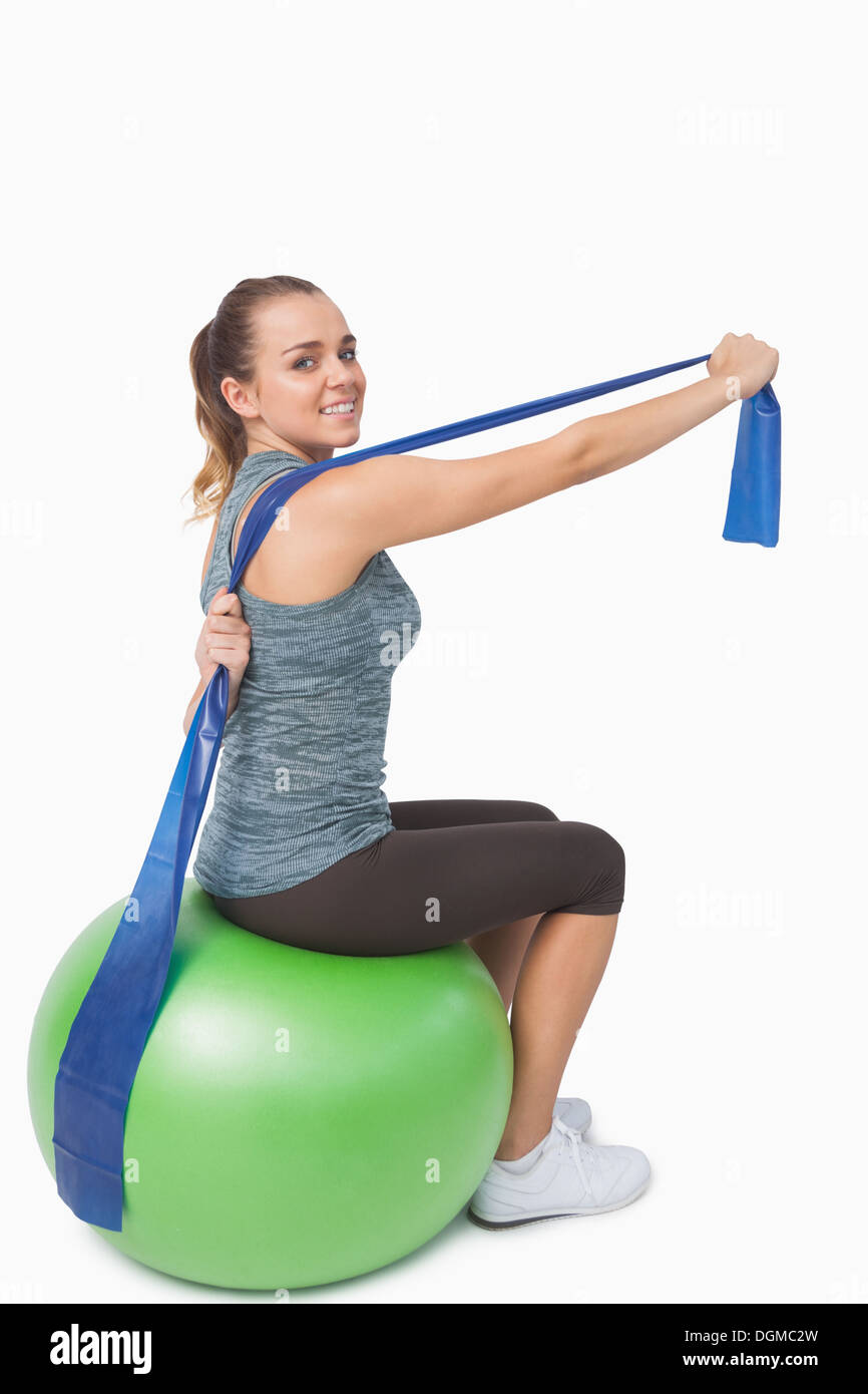 Cheerful woman stretching her arms using a resistance band Stock Photo ...