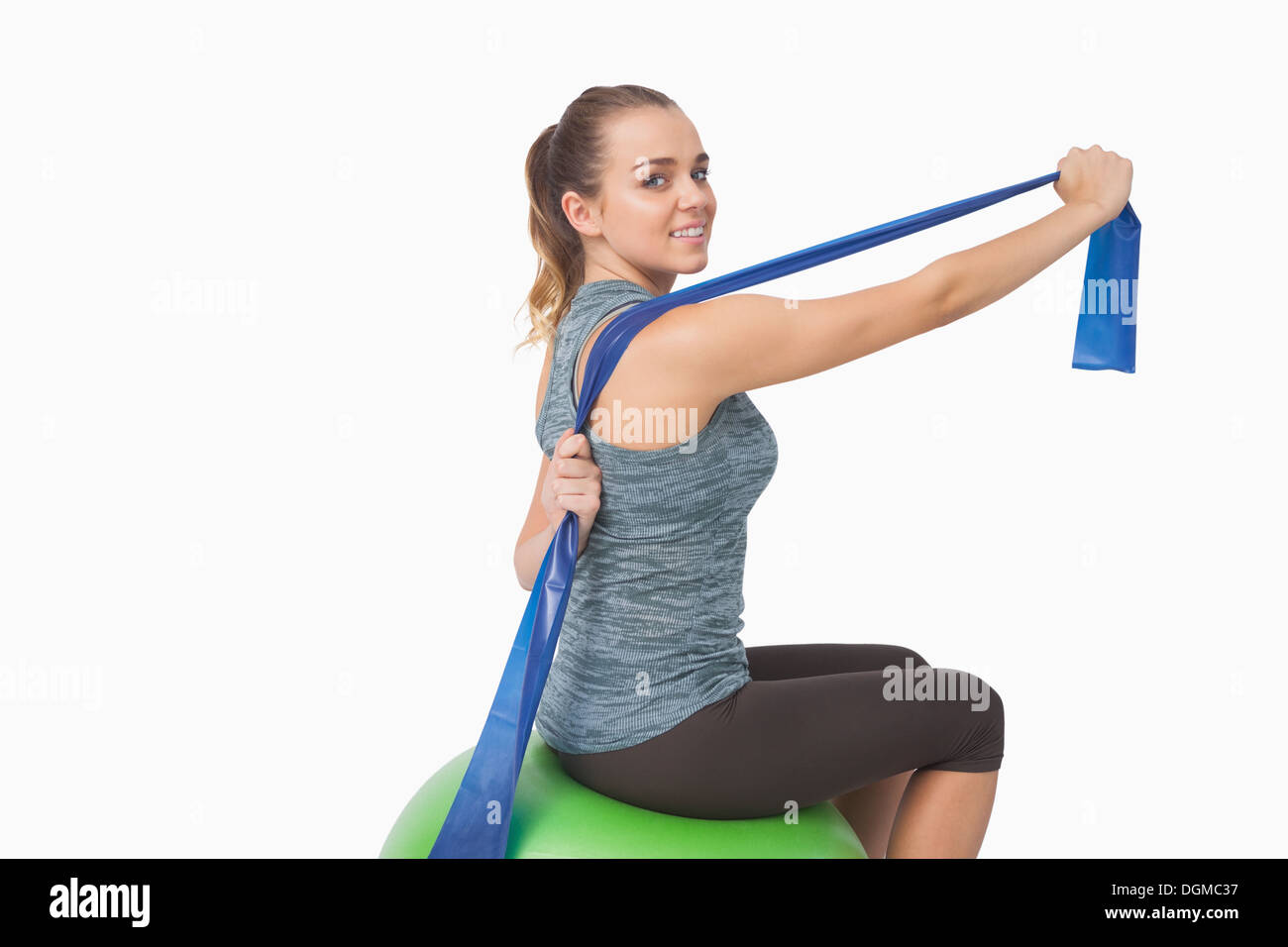 Pretty fit woman stretching her arms with a resistance band Stock Photo ...