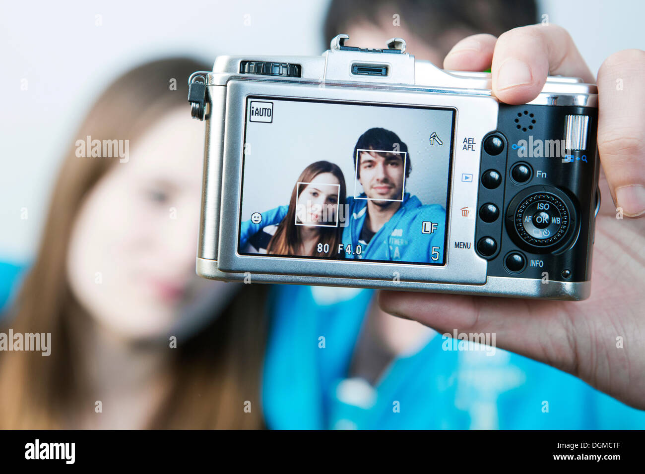 Couple taking pictures of themselves, self-portrait on the display of ...