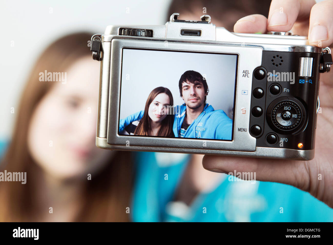 Couple taking pictures of themselves, self-portrait on the display of ...