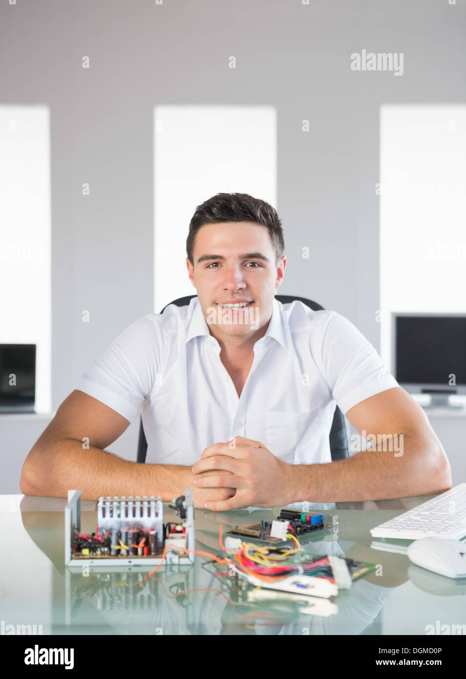 Handsome man sitting desk hi-res stock photography and images - Alamy
