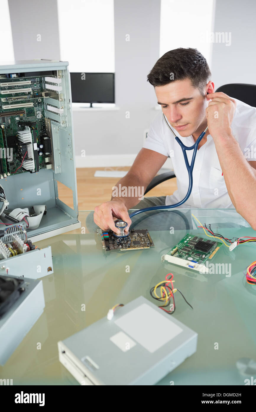 Handsome serious computer engineer holding stethoscope Stock Photo - Alamy