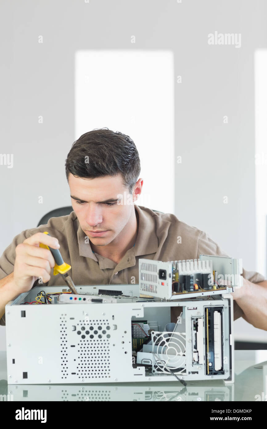 Handsome serious computer engineer repairing open computer Stock Photo ...