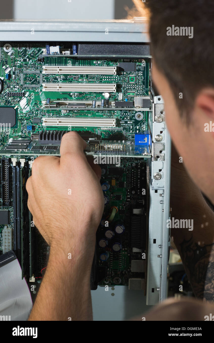 Computer engineer checking open computer Stock Photo - Alamy