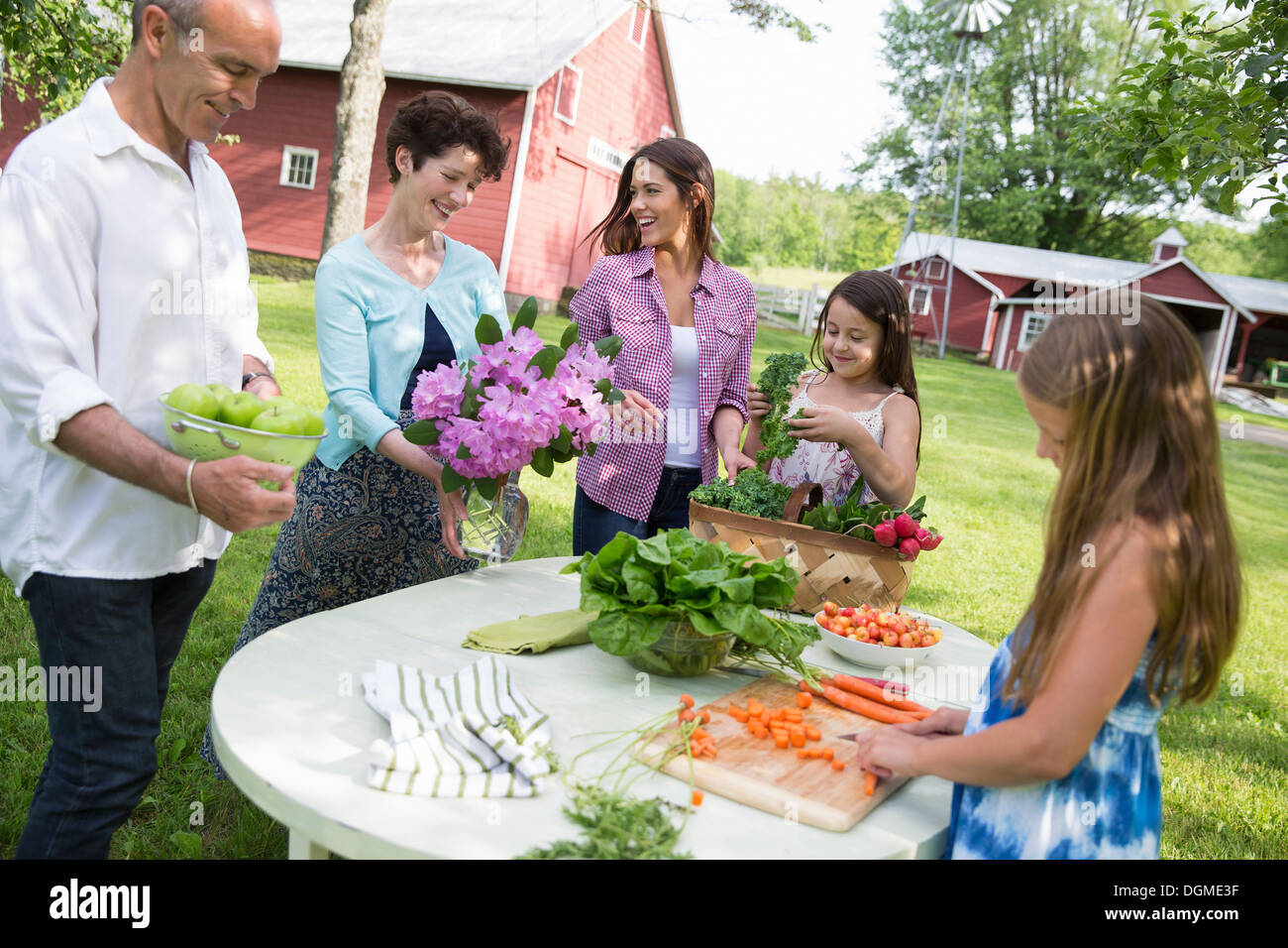 Family party. A table laid with salads and fresh fruits and vegetables ...