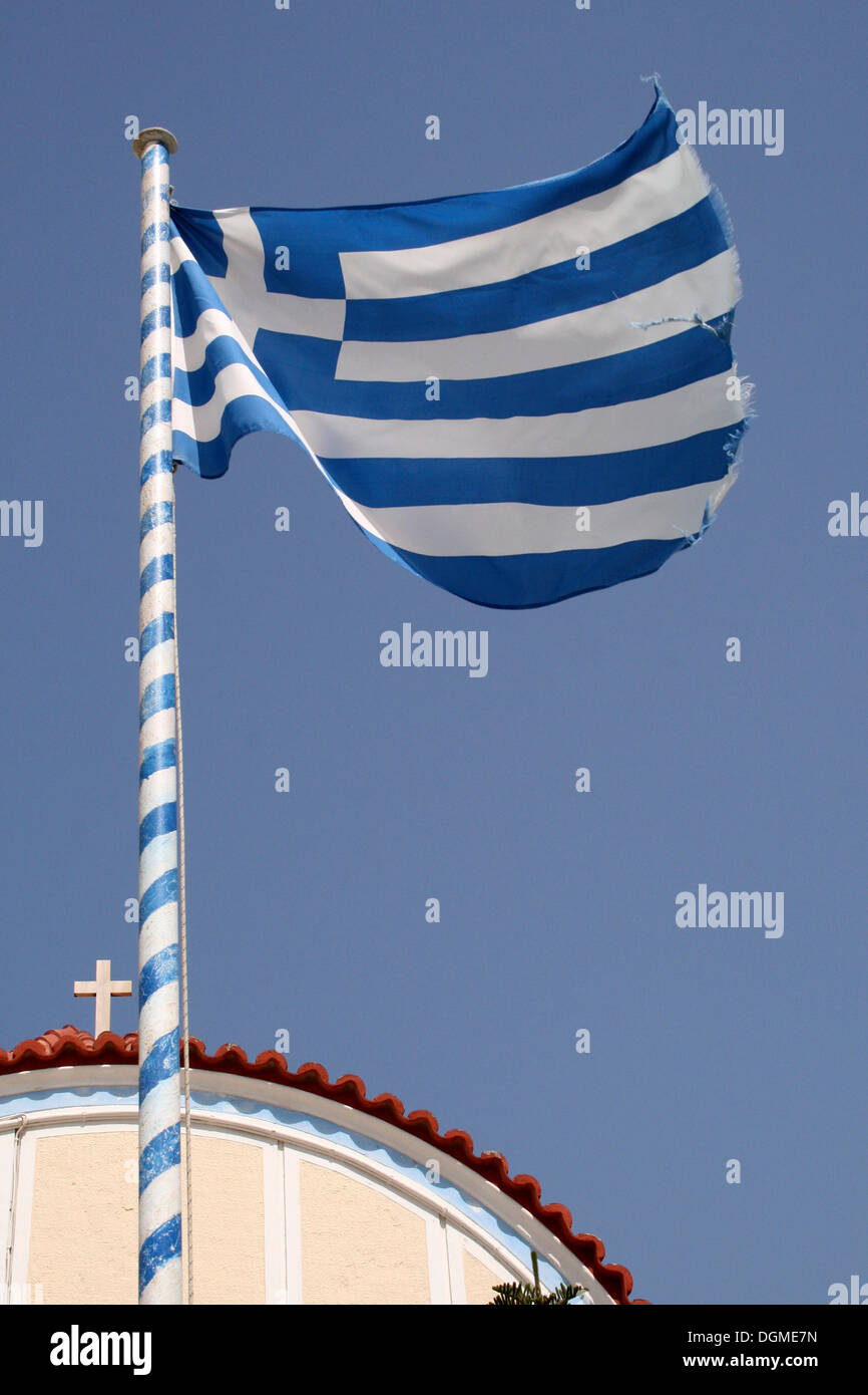 Fluttering Greek flag, Olympos, Karpathos island, Aegean Islands ...